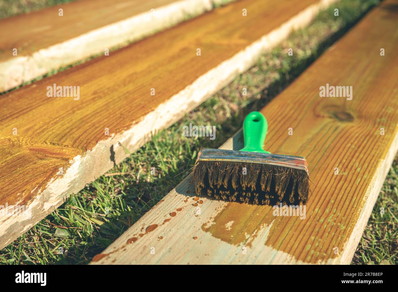 coating wooden boards with an antiseptic with a brush. construction ...