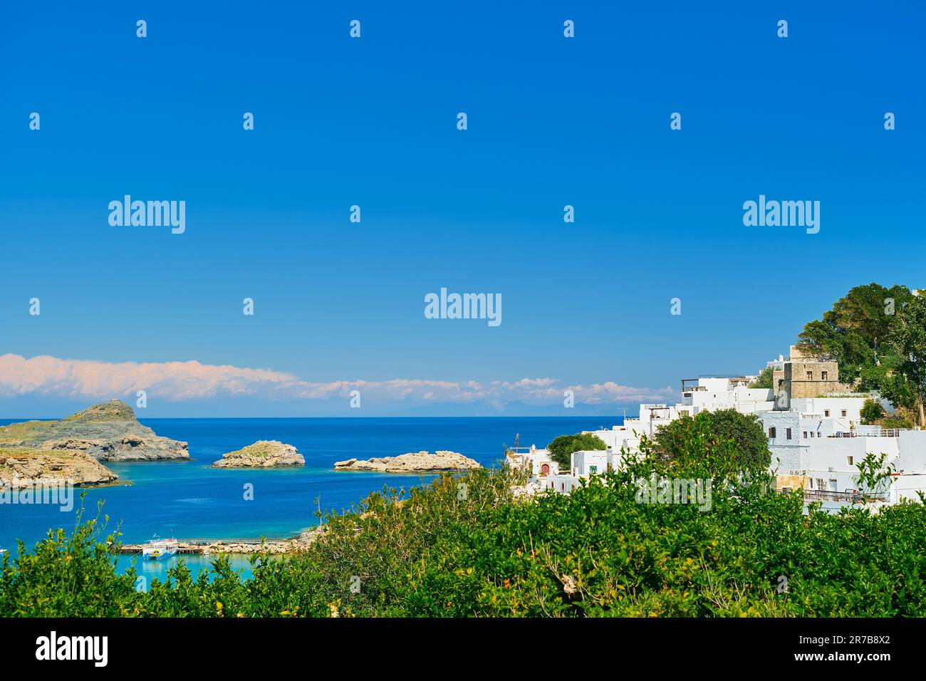 View of the bay and snow-white houses of the ancient city of Lindos on ...