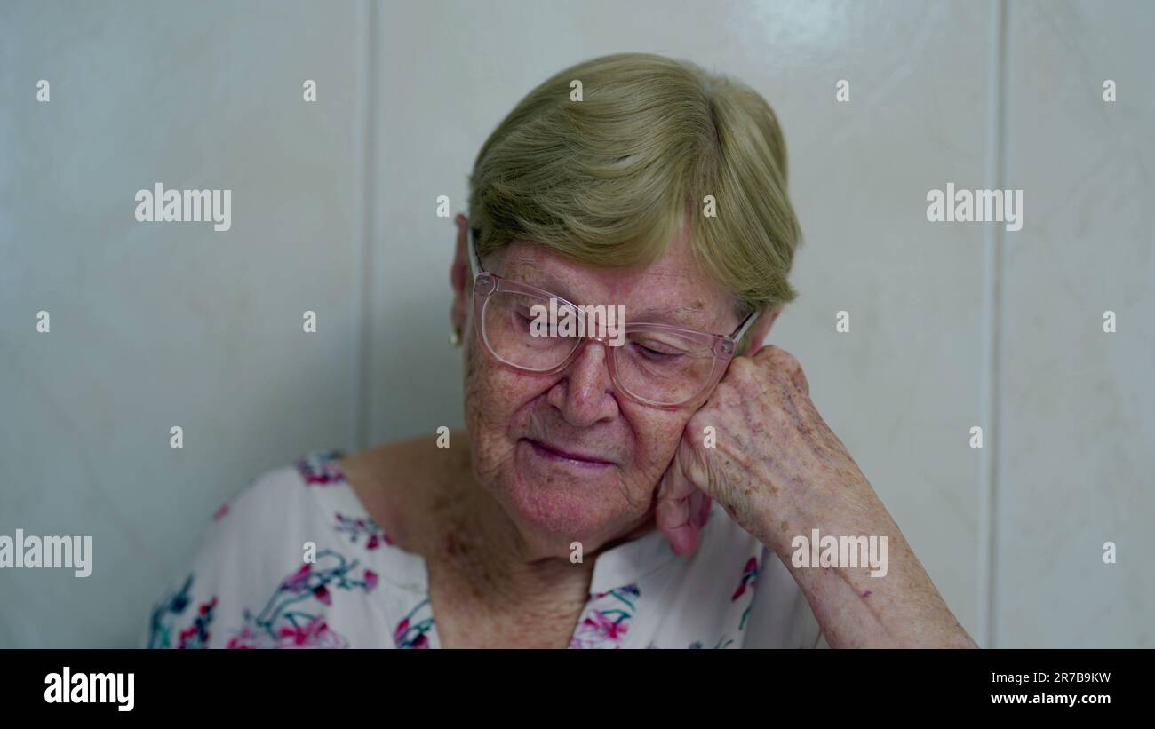 Pensive elderly woman in deep mental reflection thinking about life s ...
