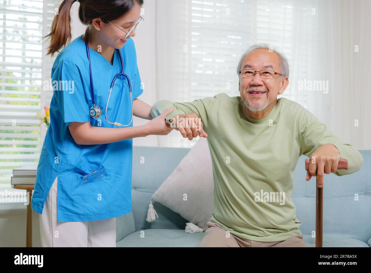 Elderly patient trying to stand and walking with caregiver nurse Stock Photo - Alamy