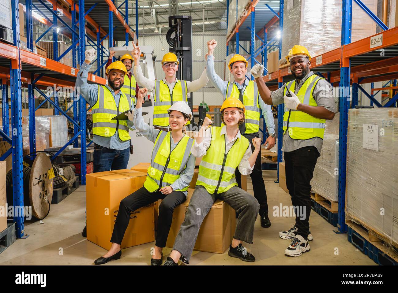 Group of happy warehouse workers celebrating success in warehouse Stock ...