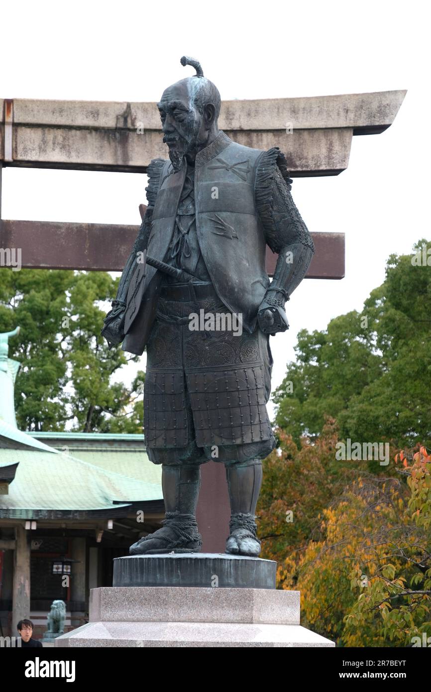 A bronze statue stands in Osaka, Japan, illuminated by the late ...