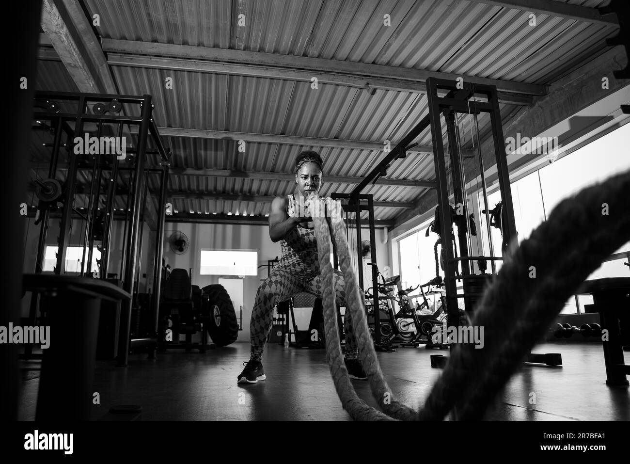 A fit female is seen exercising with a rope cardio, showcasing her ...