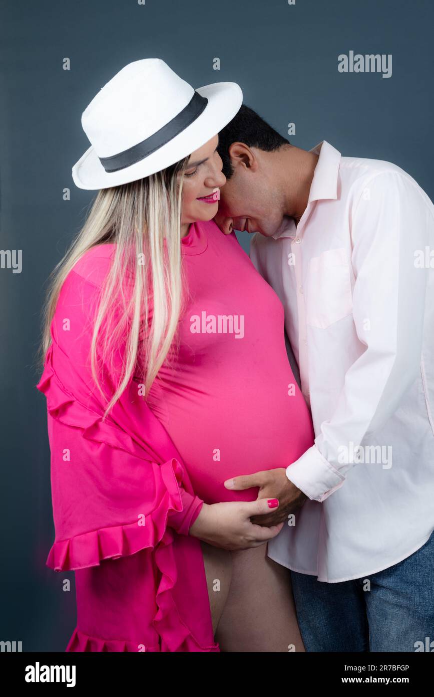 A loving couple, both with visible baby bumps, embrace each other ...