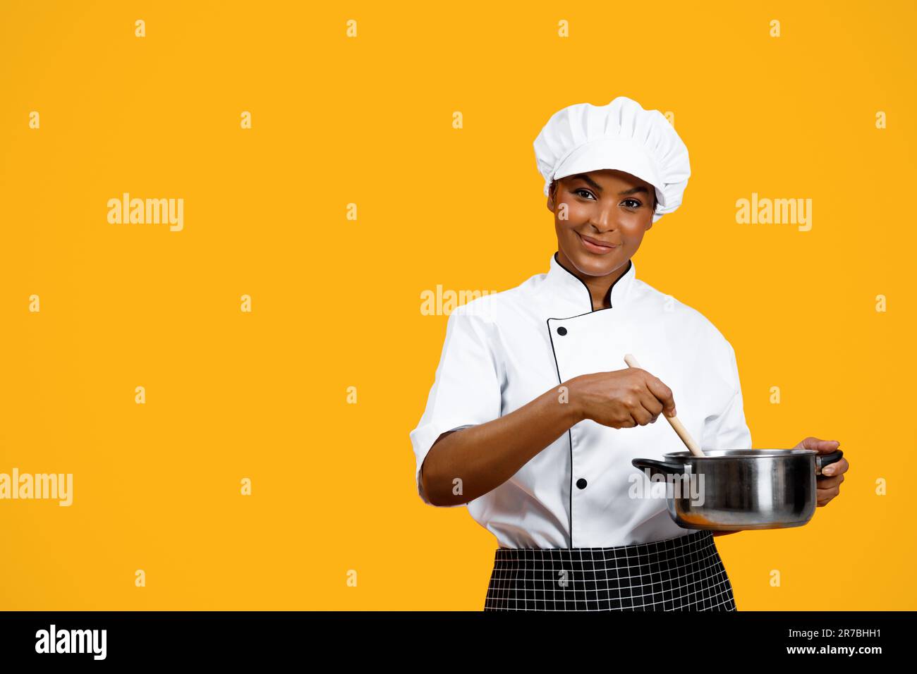 Culinary Concept. Smiling black female chef holding saucepan and ...