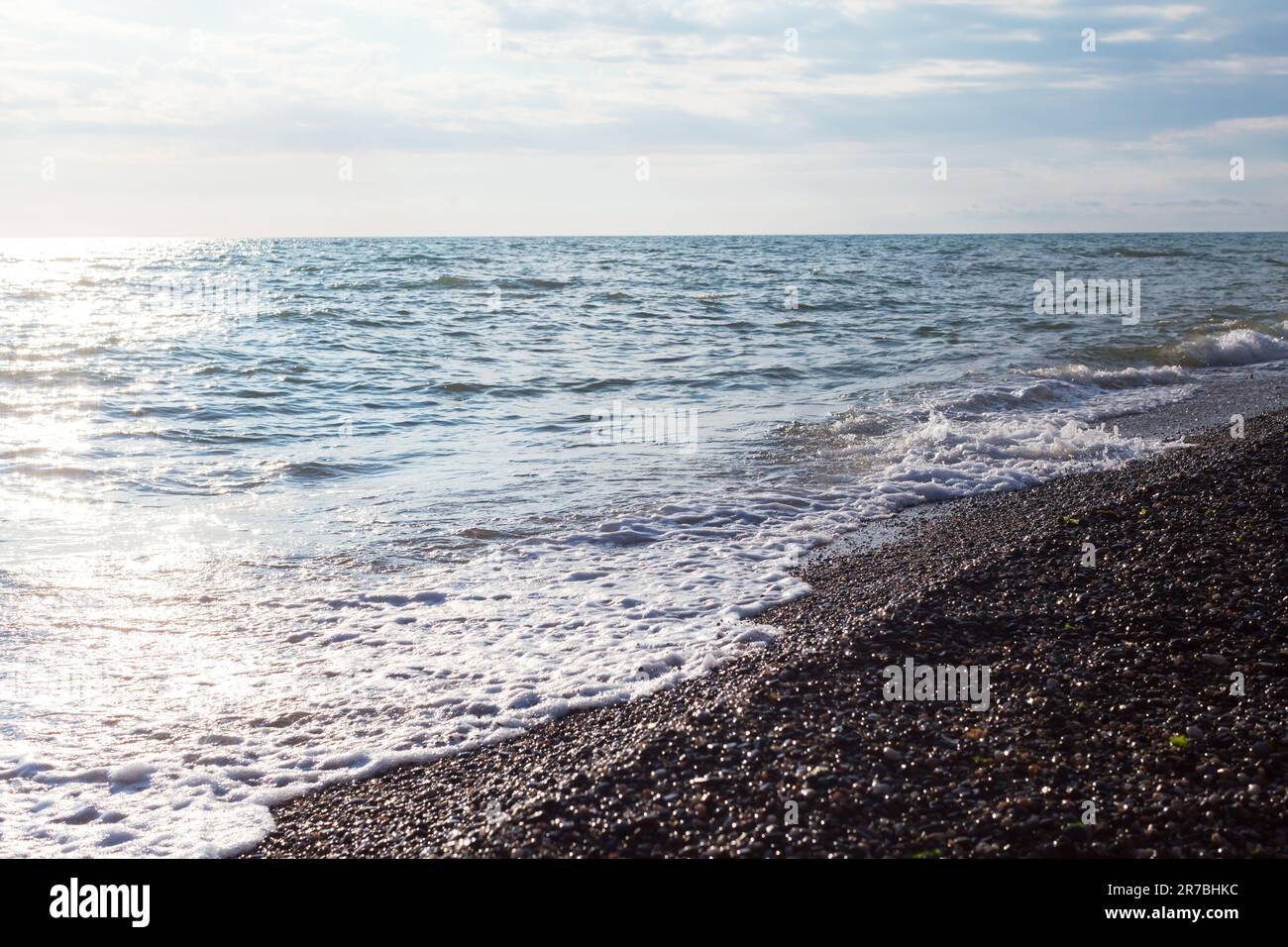 Sea surf on a stony beach Stock Photo - Alamy