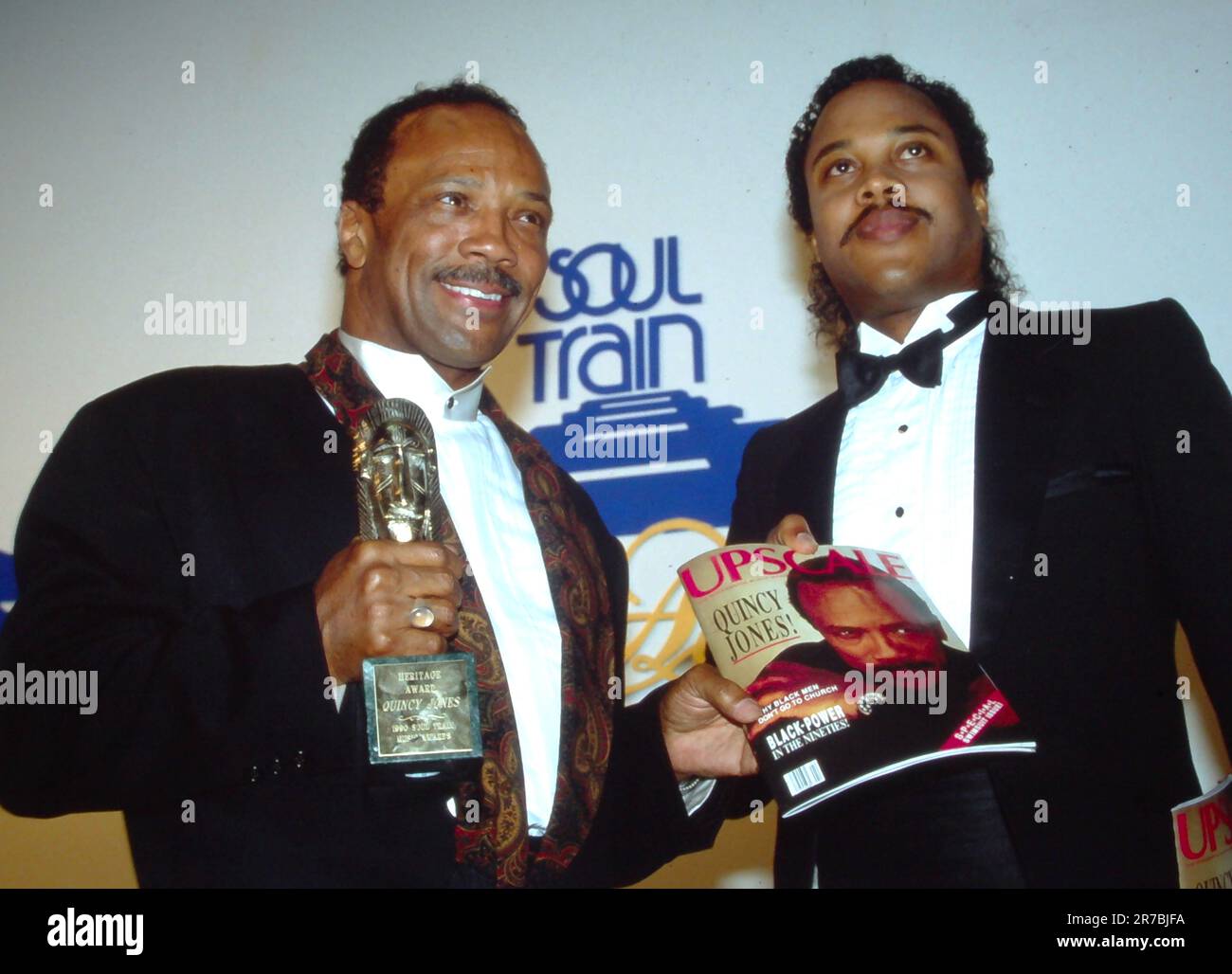 A portrait of Quincy Jones with his Heritage Award for Career ...
