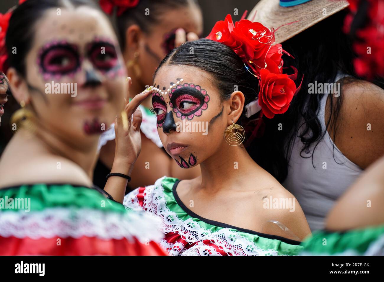 Mexican women performers dressed in the costume of a skeleton prepare ...