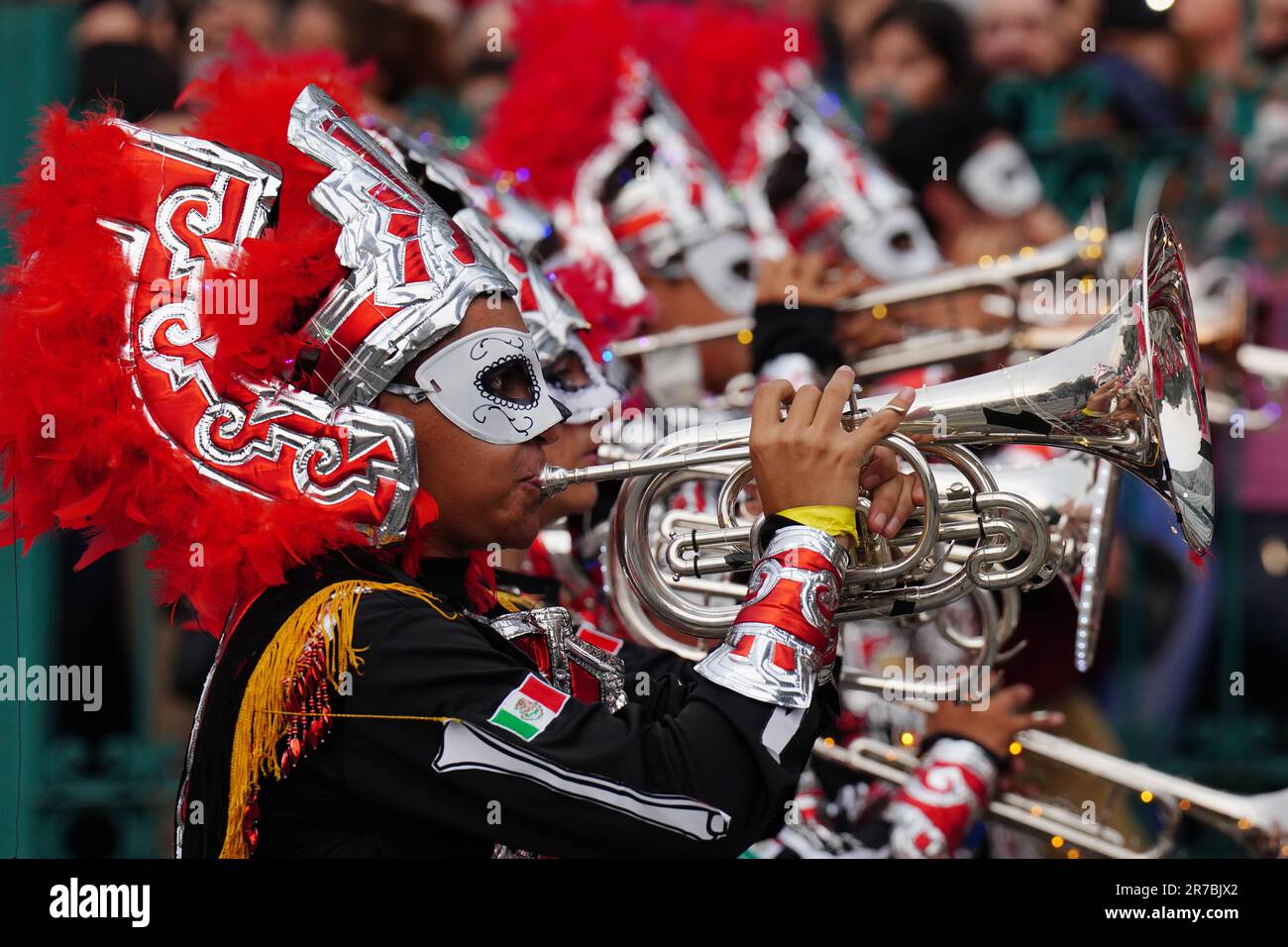 A marching band in Mayan costumes march in the Grand Parade of the Dead ...