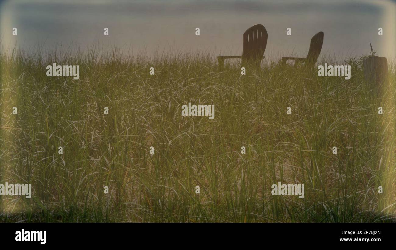 Empty lawn chairs on the grassy hill under blue sky in summer Stock ...