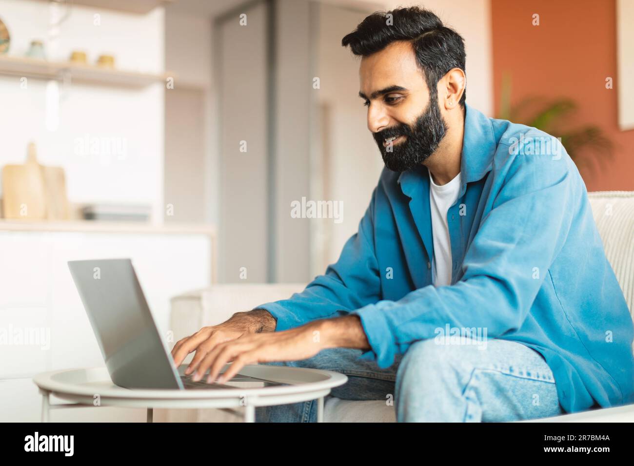 Middle eastern guy freelancer working online with laptop from home ...