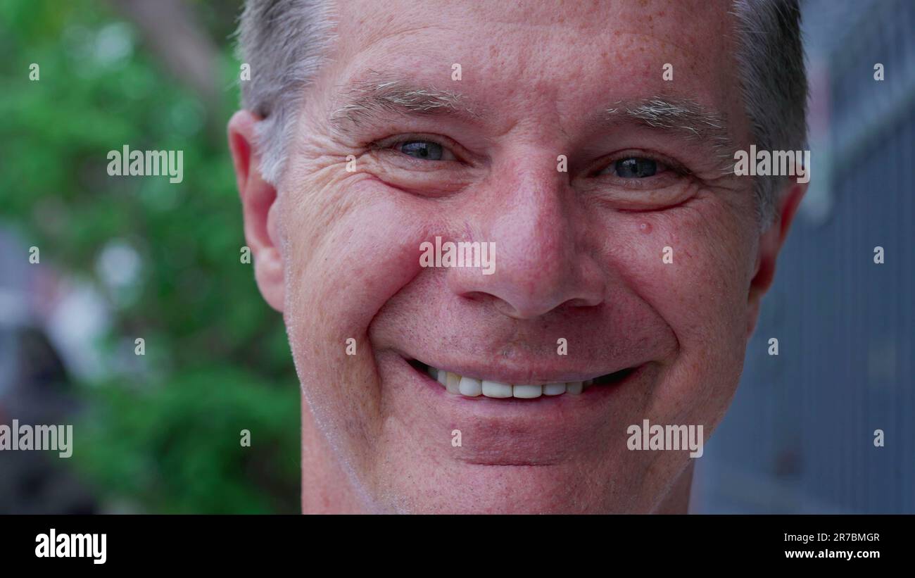 Happy middle-aged man macro close-up face looking at camera smiling ...