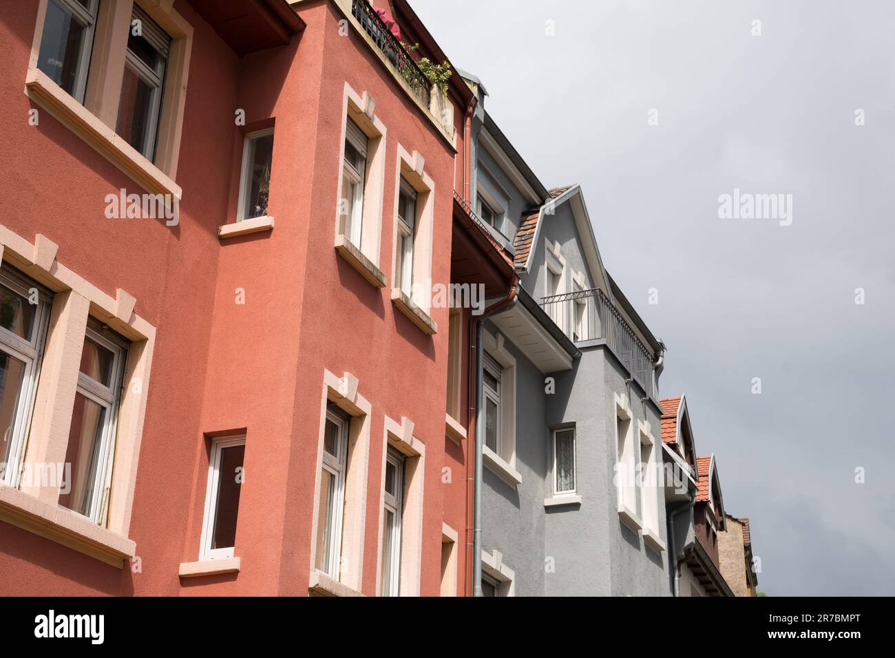A beautiful row of modern multi-colored buildings with doors and ...