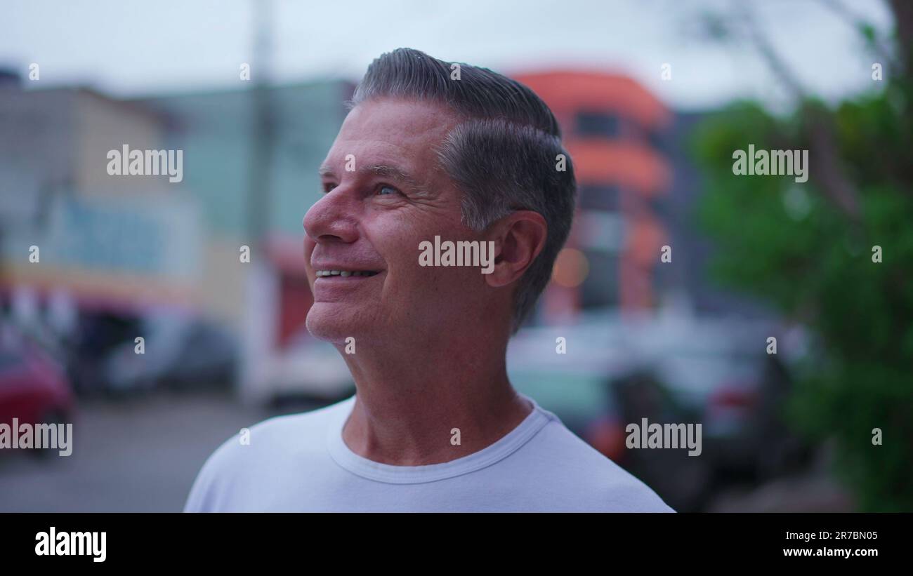 Happy senior man looking at sky with HOPE and FAITH. A middle-age ...