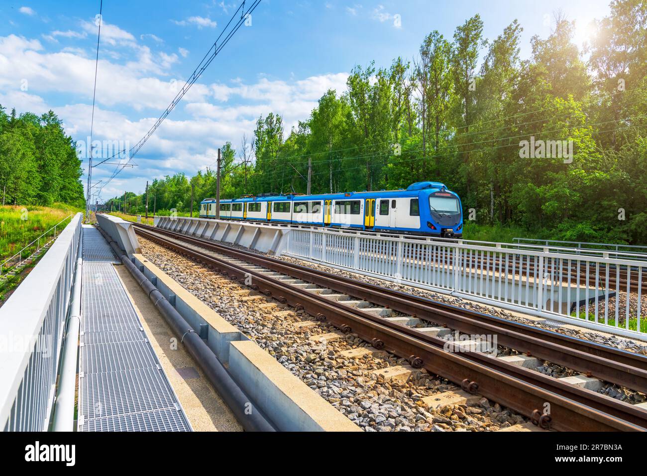 Railway traction. Passenger train on the railway bridge Stock Photo - Alamy