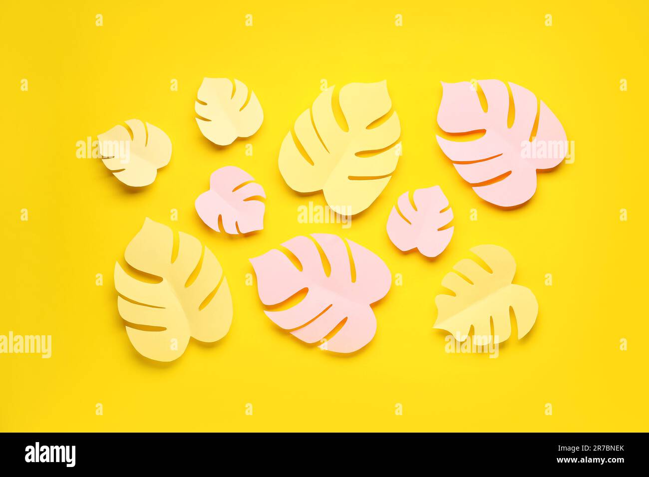 Paper tropical leaves on yellow background Stock Photo - Alamy