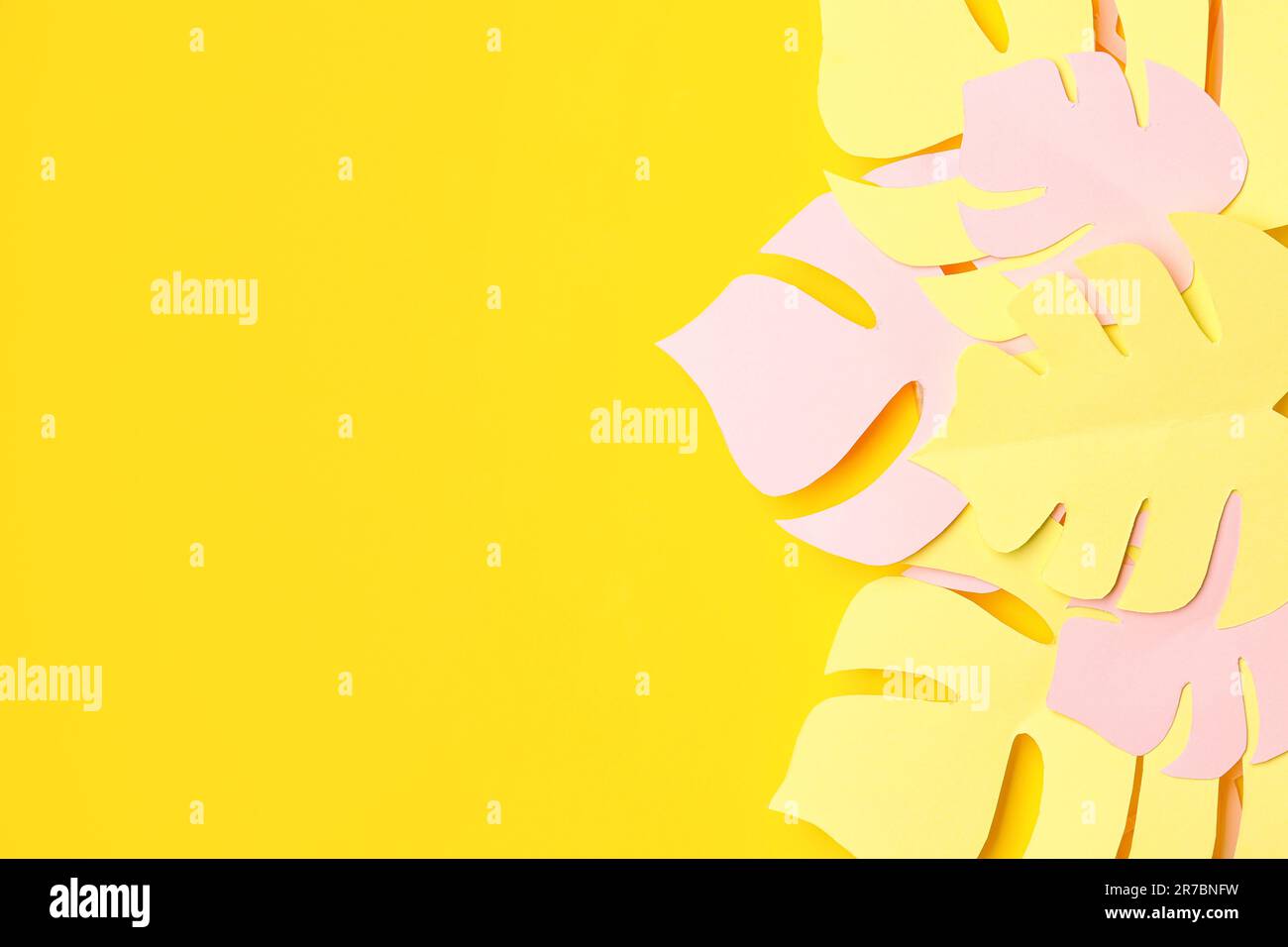 Paper tropical leaves on yellow background Stock Photo - Alamy