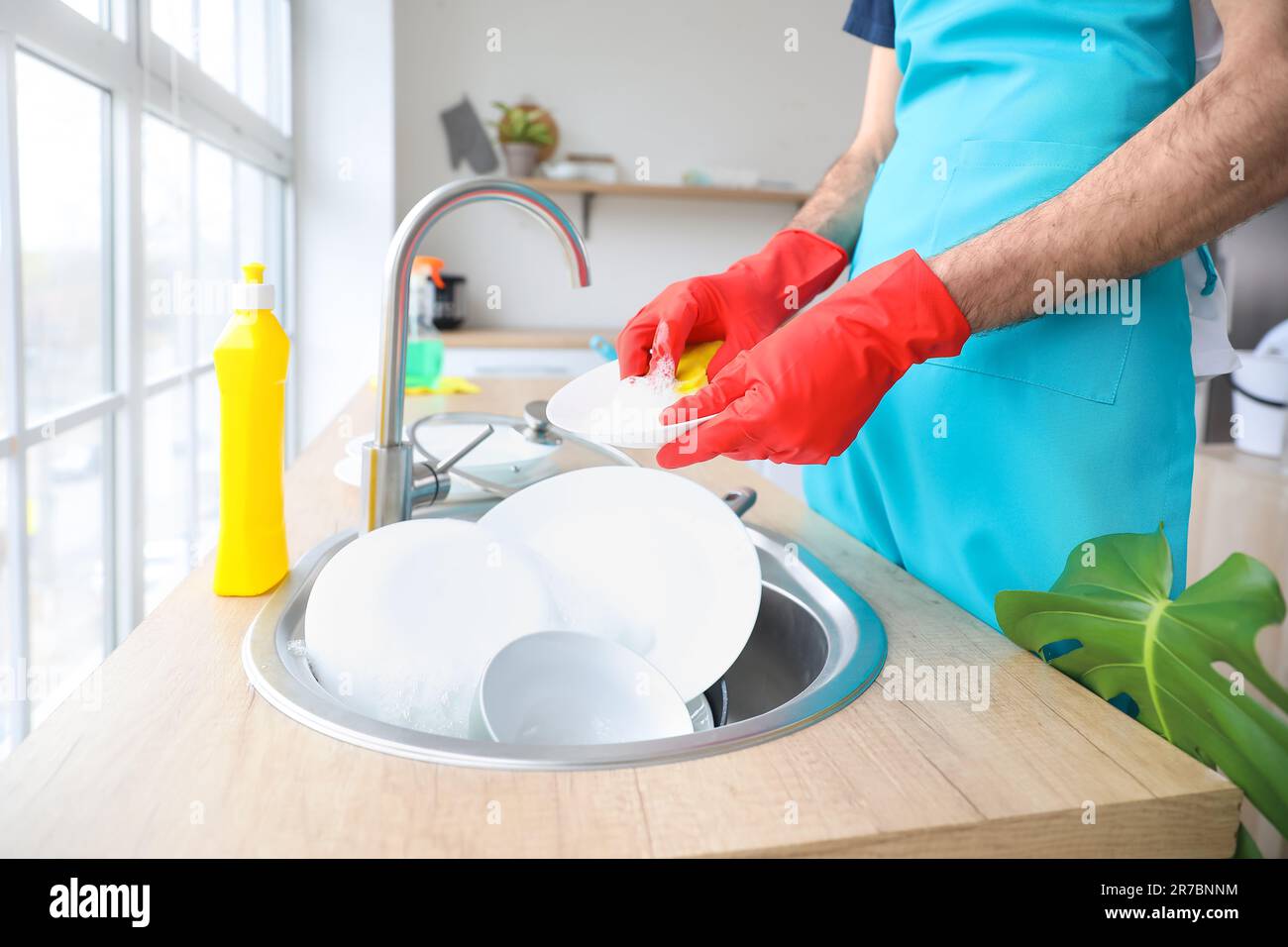 Young man washing dishes in kitchen Stock Photo - Alamy