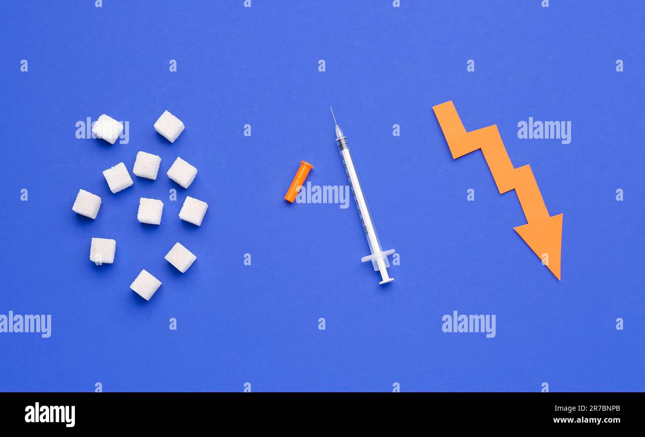 Sugar cubes with syringe for insulin injection and arrow directed ...