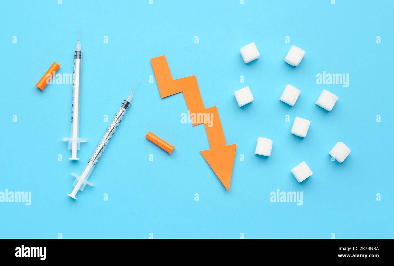 Sugar with syringes for insulin injection and arrow directed downwards ...
