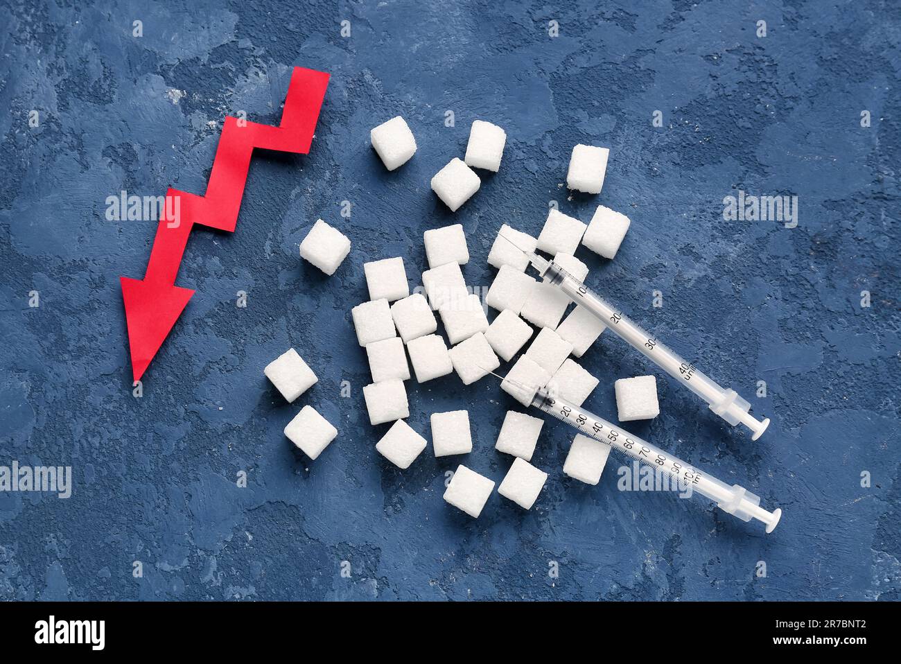 Sugar cubes with syringes for insulin injection and arrow directed ...