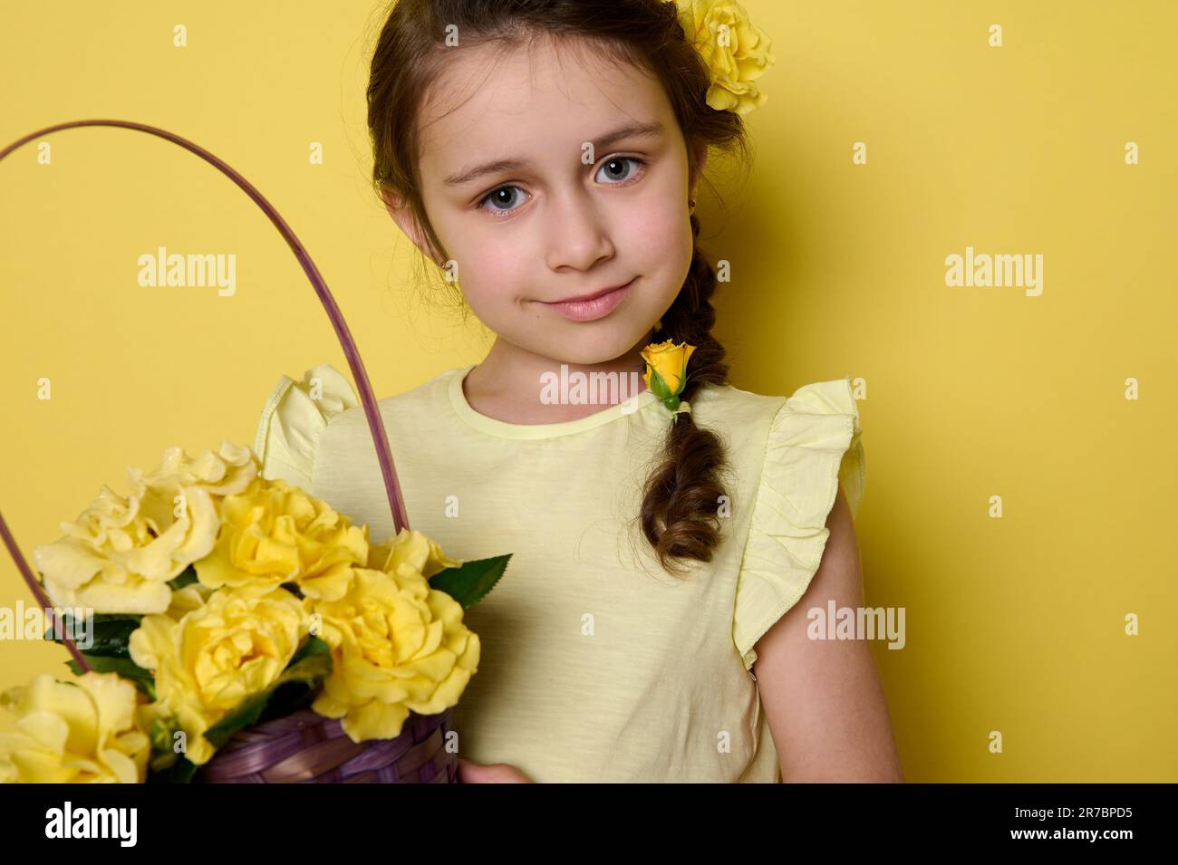 Close-up beautiful blue eyed little kid girl in yellow dress and ...