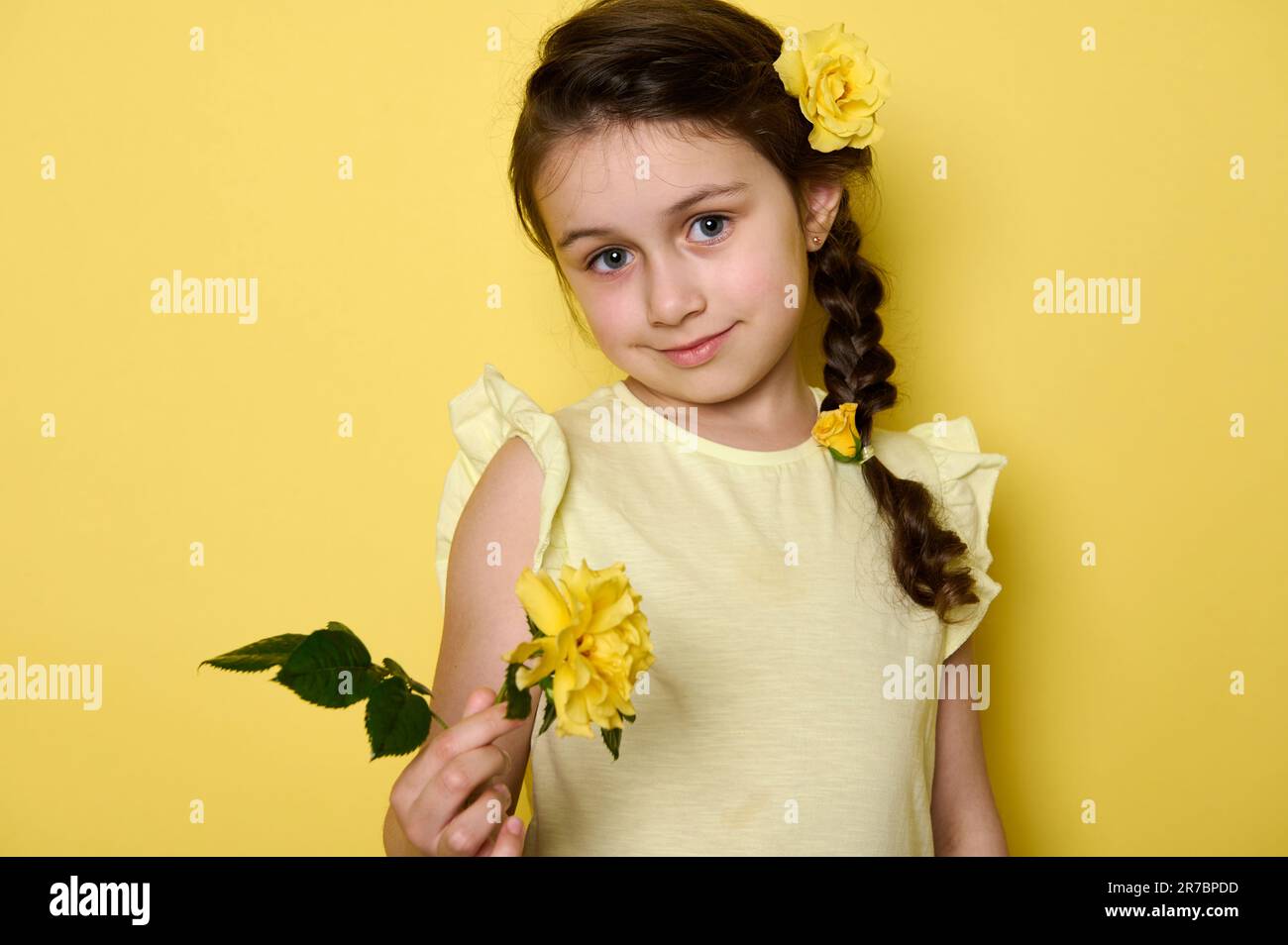 Beauty portrait of a Caucasian noble charming baby girl in yellow dress ...