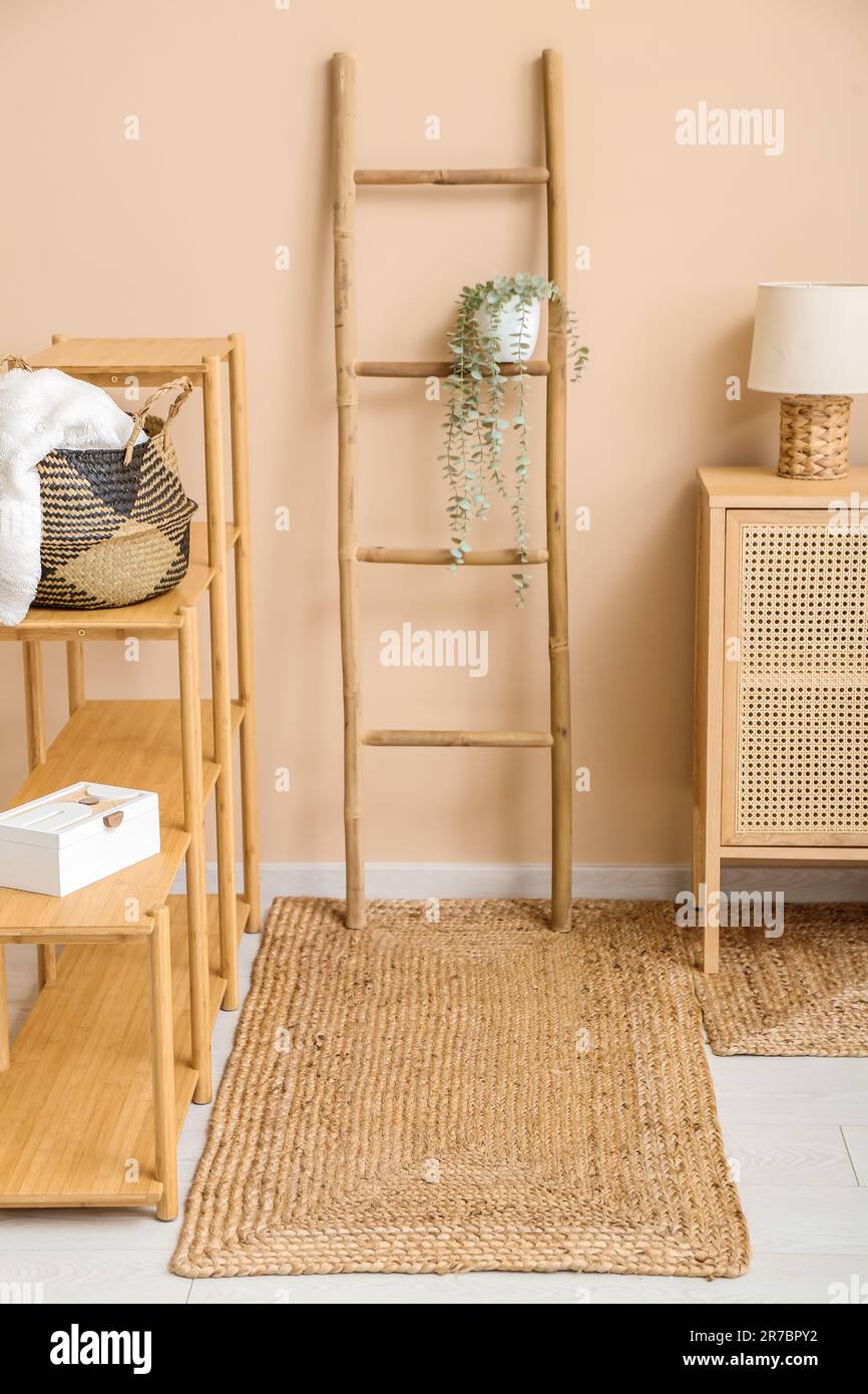 Stylish interior of living room with shelving unit, ladder, drawers and ...