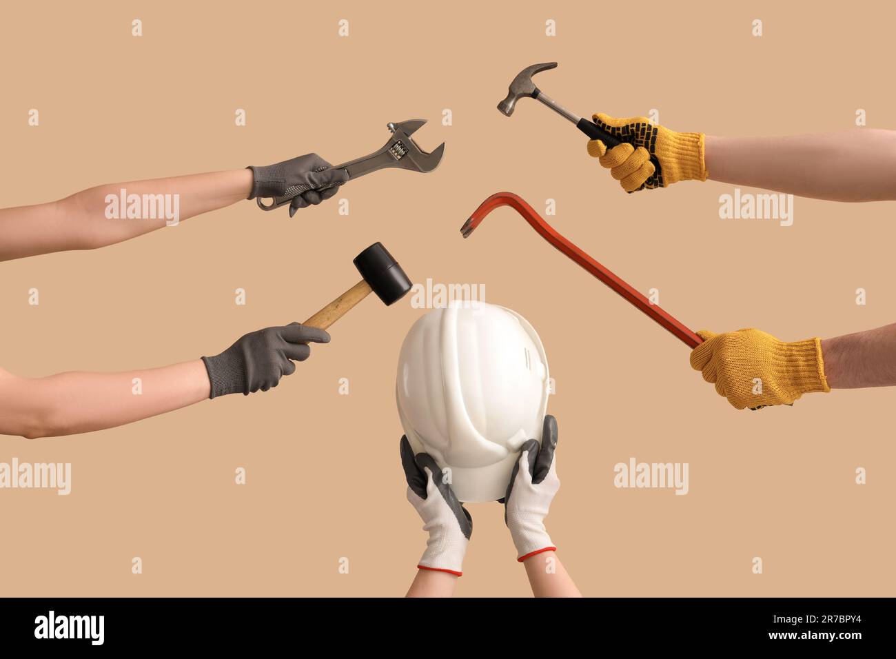 Female and male hands holding different construction tools and safety ...