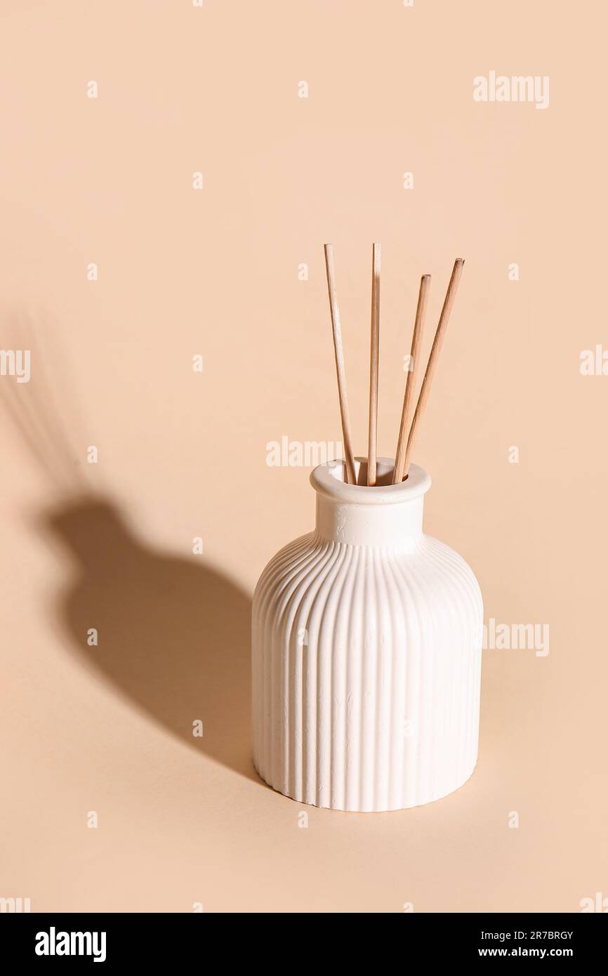 Bottle of reed diffuser on beige background Stock Photo - Alamy