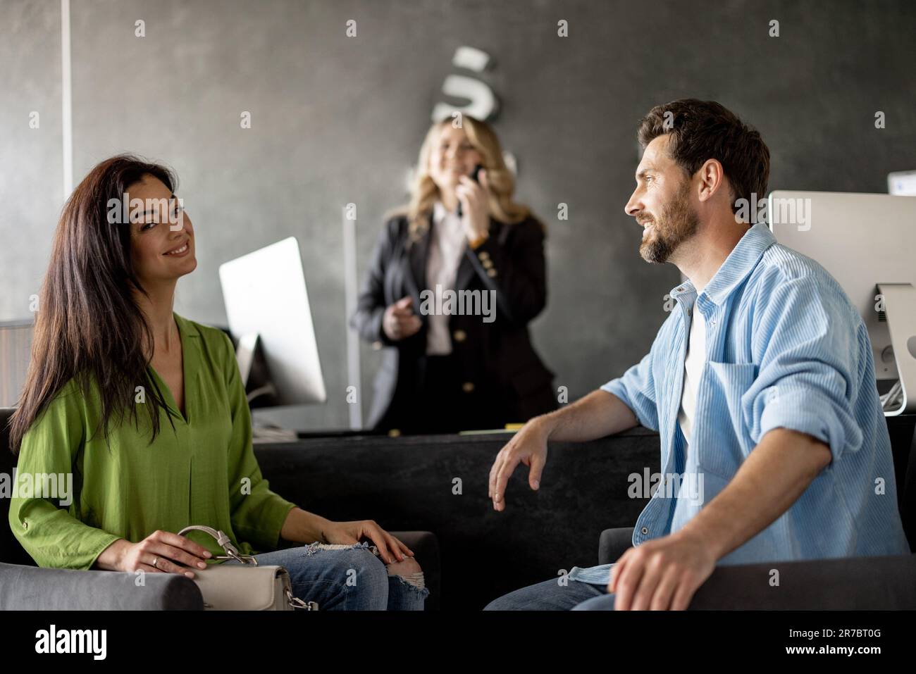 Man and woman at the reception desk of a modern clinic Stock Photo - Alamy