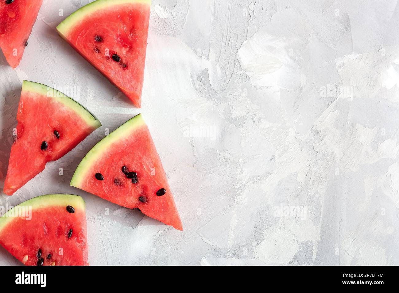 Pieces of fresh watermelon on grey background Stock Photo - Alamy