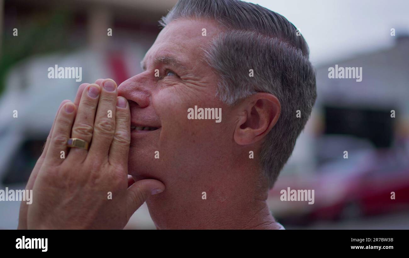 Religious Senior man standing on street in Prayer. Devoted middle-age ...