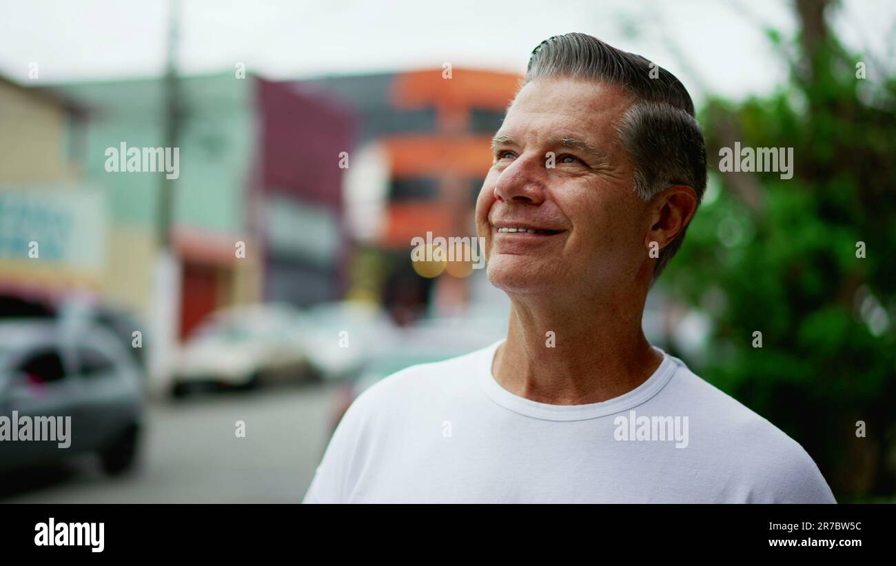 Senior man raising head to sky smiling, Hopeful expression of an older ...