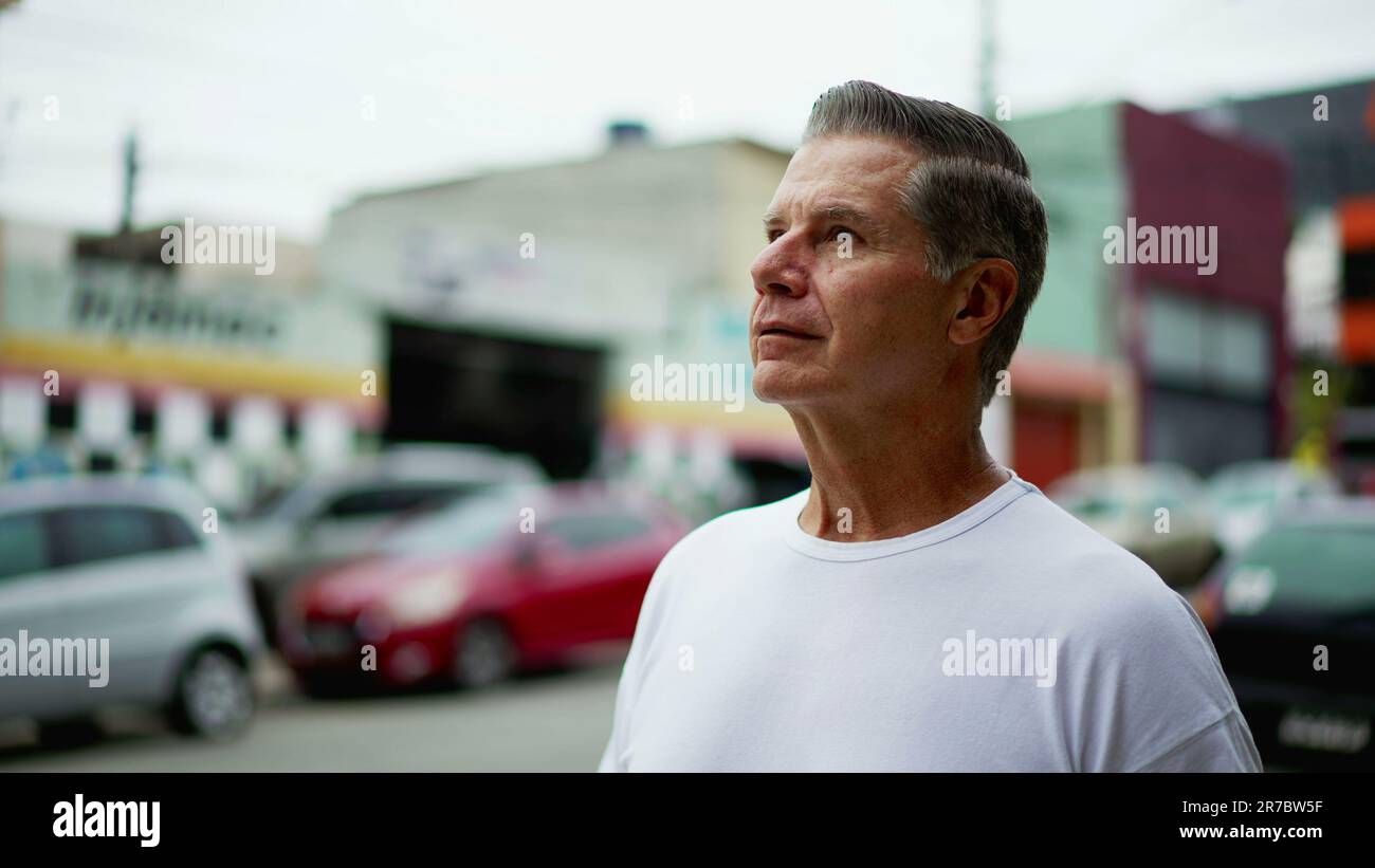 Senior man raising head to sky smiling, Hopeful expression of an older ...