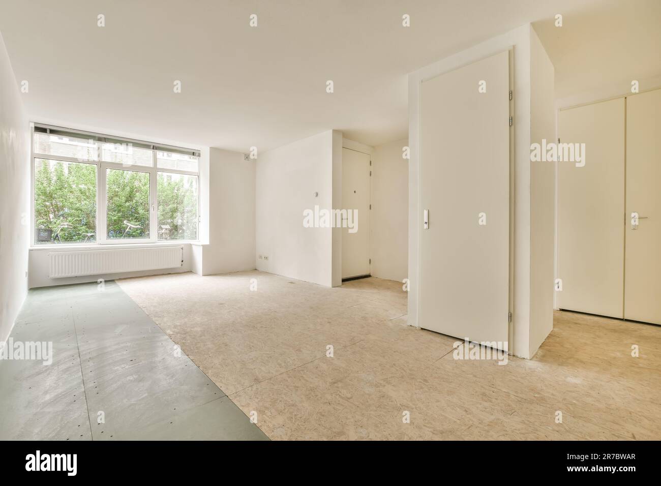 an empty room with white walls and floorboards on the wall, there is no ...