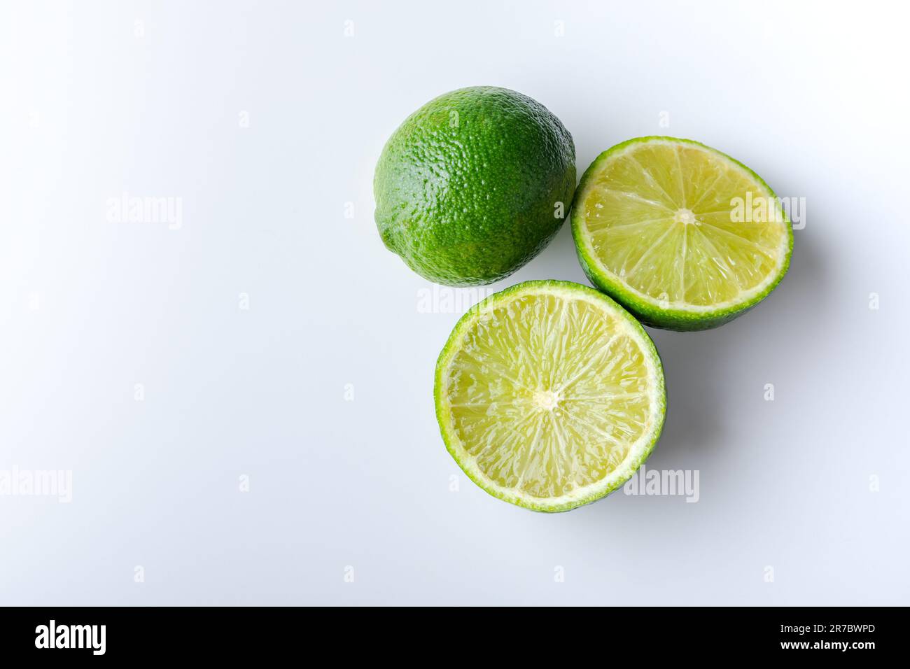 Fresh lime fruit with cut in half slice isolated on white background ...