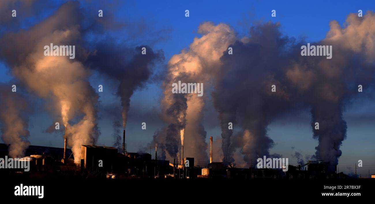 Factory chimneys spewing pollution into the sky smoke rising pollutants ...