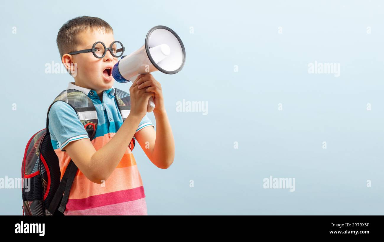 Little schoolboy with megaphone on blue background. Boy with megaphone ...