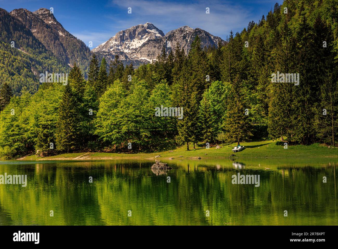 lakeside image of the snow capped mountains of the julian alps ...