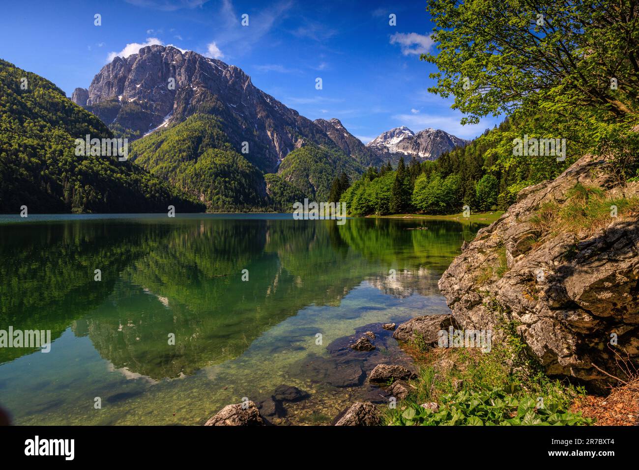 lakeside image of the snow capped mountains of the julian alps ...