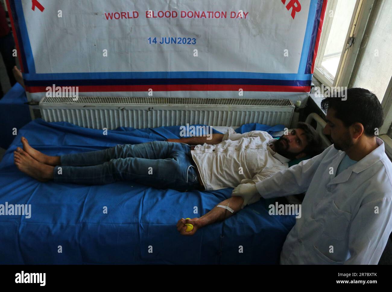 Srinagar Kashmir, India. 14th June, 2023. A man squeezes a sponge ball ...