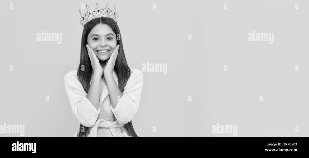 smug happy teen girl in home terry bathrobe and princess crown ...