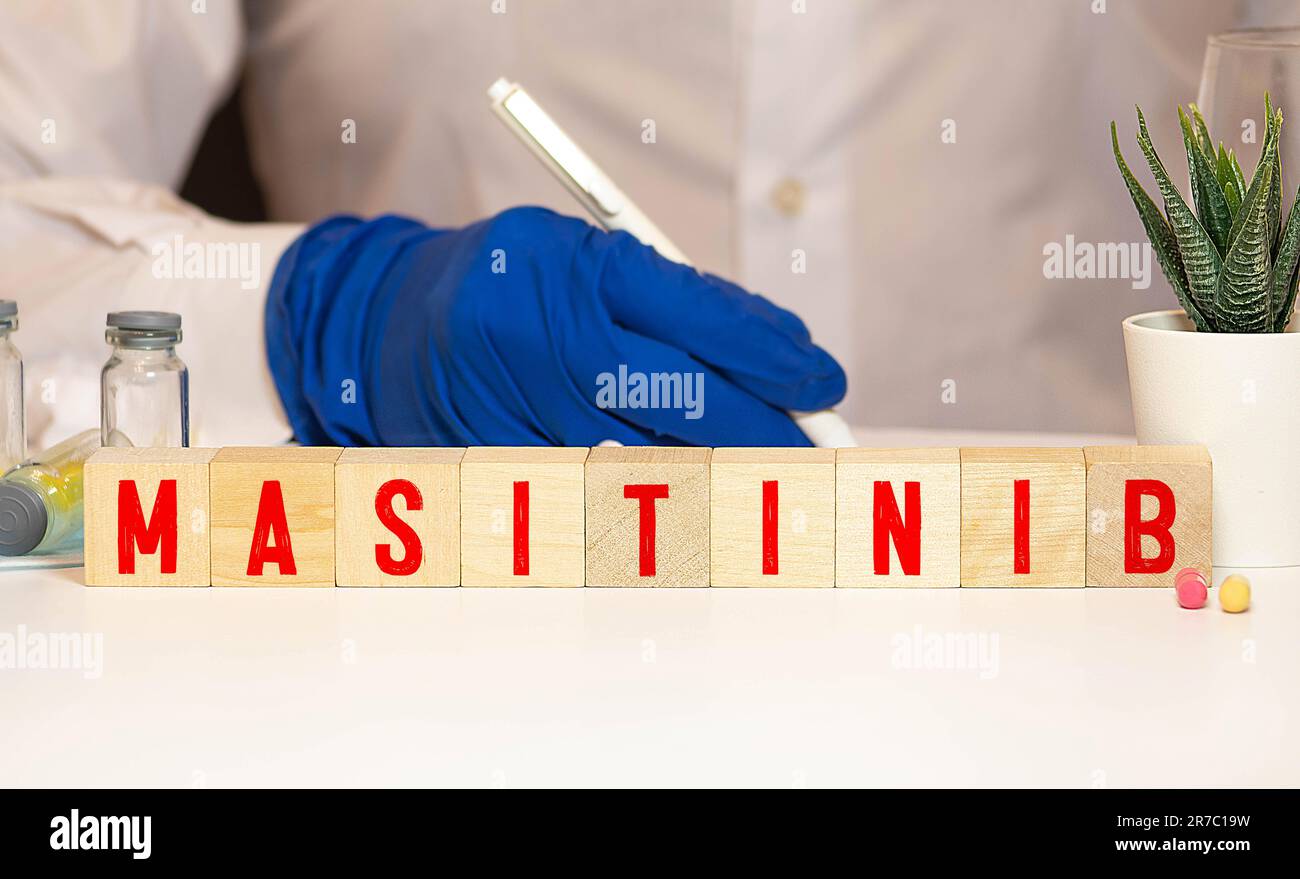 Masitinib chemical formula, structural formula. White pills close up on ...