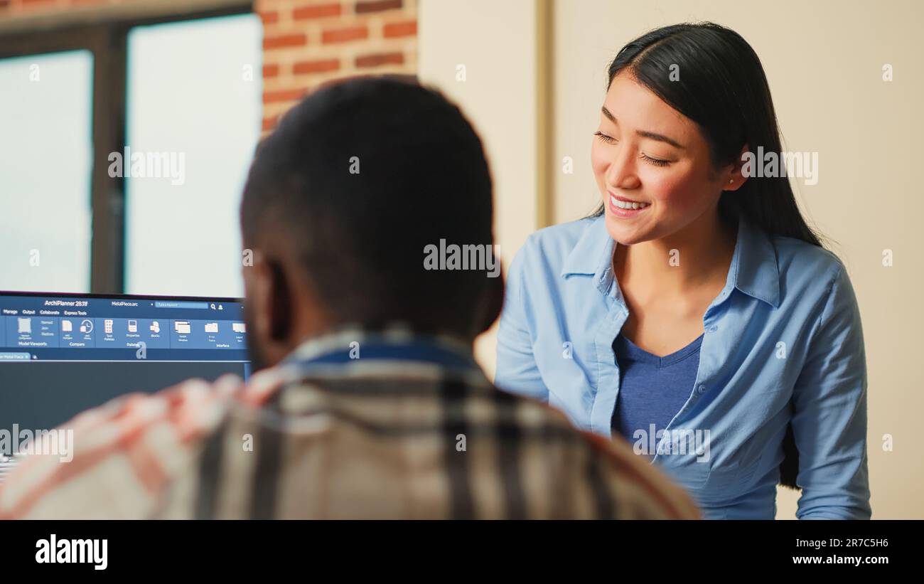 Female digital technician helping 3d artist to develop cad prototype ...