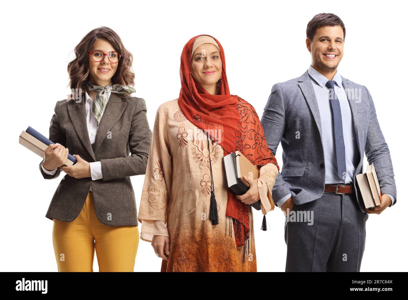 Different ethnicity teachers holding books and posing isolated on white ...
