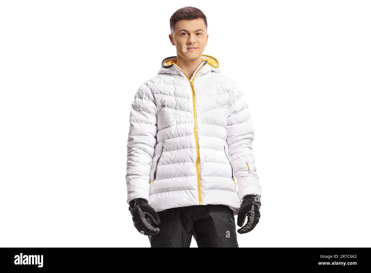 Guy in a white winter jacket and skiing pants isolated on white ...