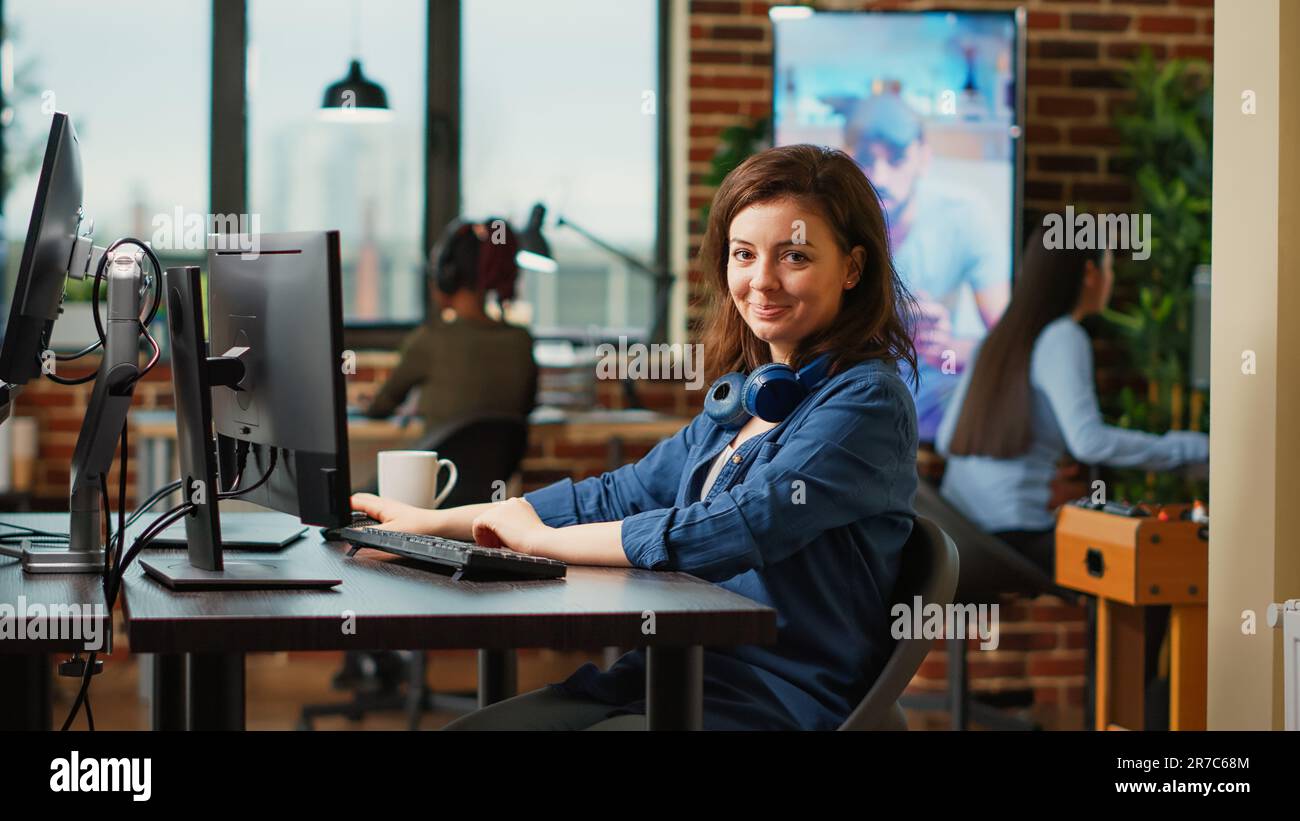 Smiling engineering specialist planning machinery component development on cad software. Happy ...