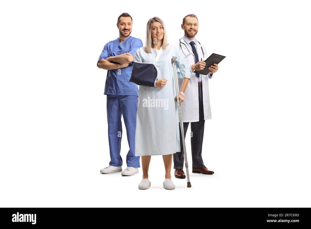 Female patient in a hospital gown standing in front of male health care ...