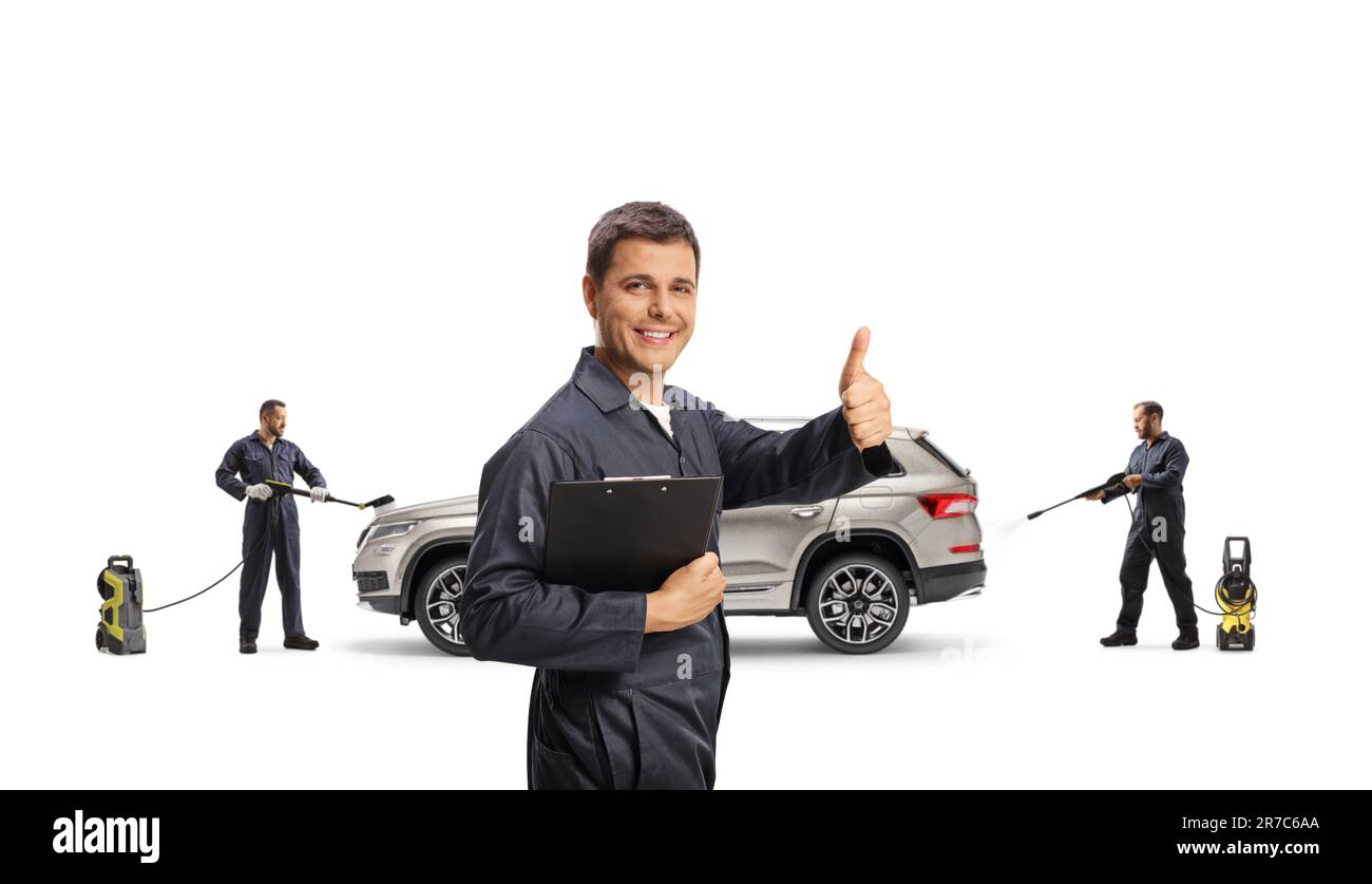 Workers in uniforms washing a SUV with a pressure washer machines and a ...